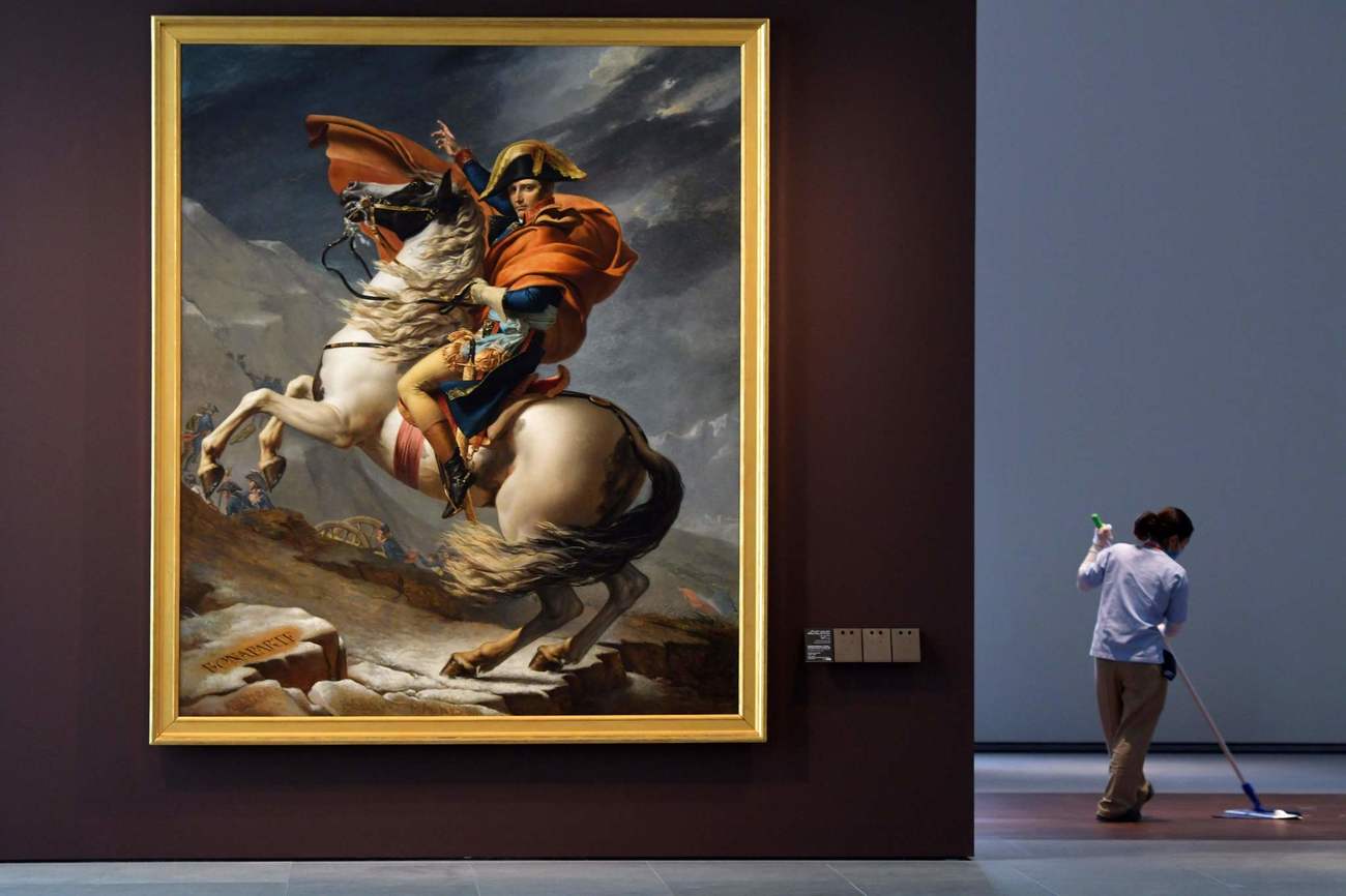 Una limpiadora junto a la pintura titulada "Napoleón Bonaparte, primer ...